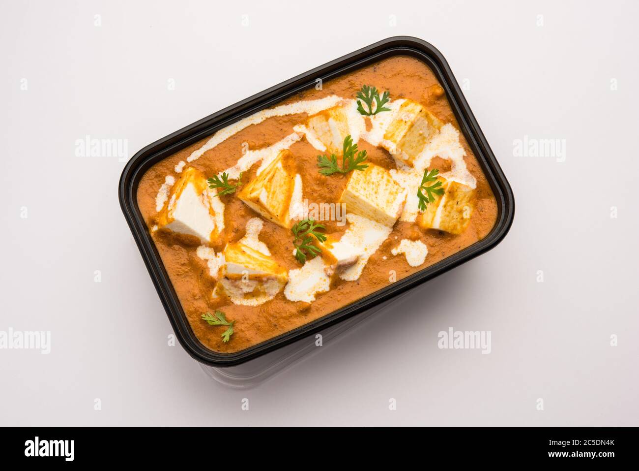 Paneer Butter Masala packed in plastic container or box, ready for home ...
