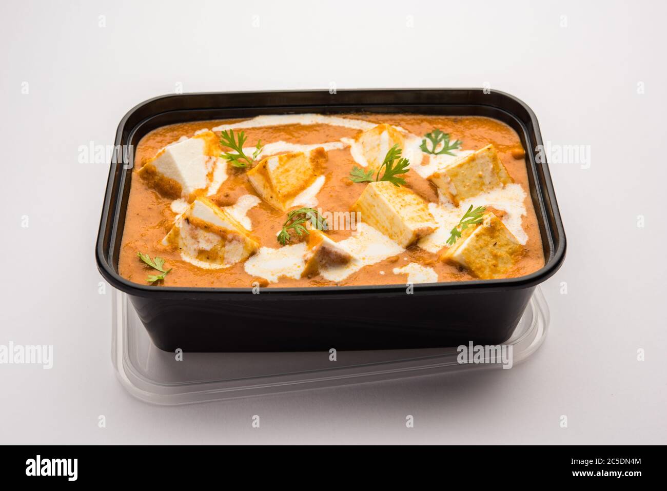 Paneer Butter Masala packed in plastic container or box, ready for home ...