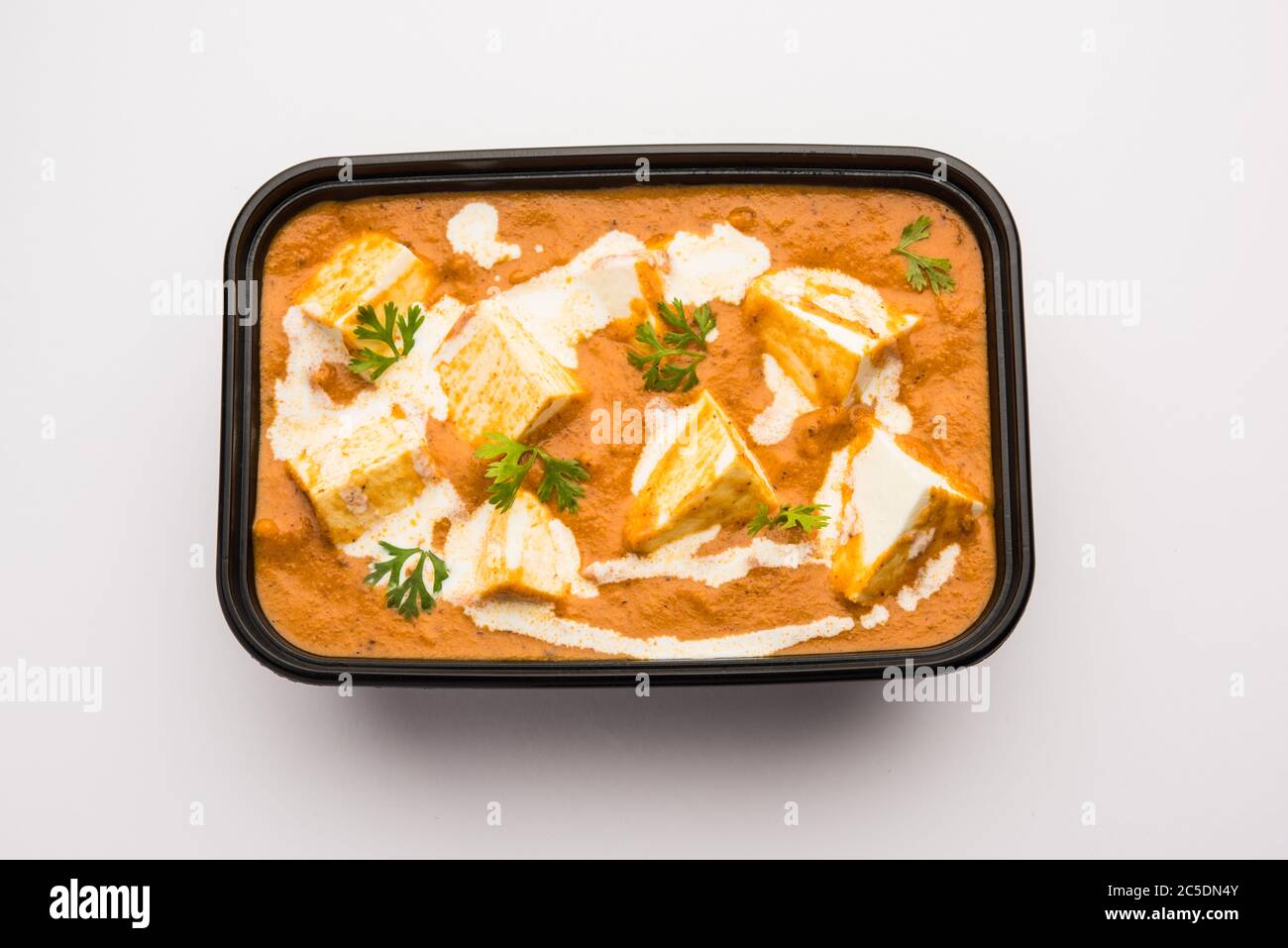 Paneer Butter Masala packed in plastic container or box, ready for home ...