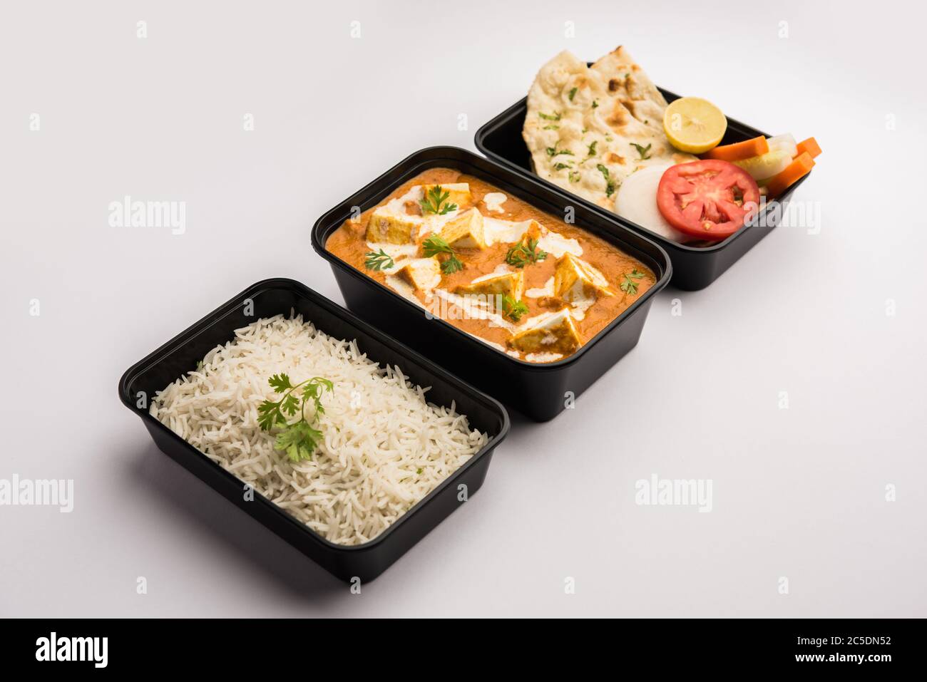 Paneer Butter Masala packed in plastic container or box, ready for home ...