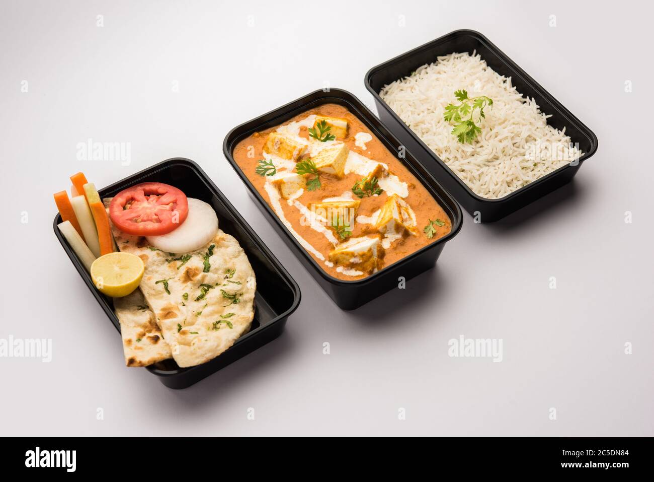 Paneer Butter Masala packed in plastic container or box, ready for home ...