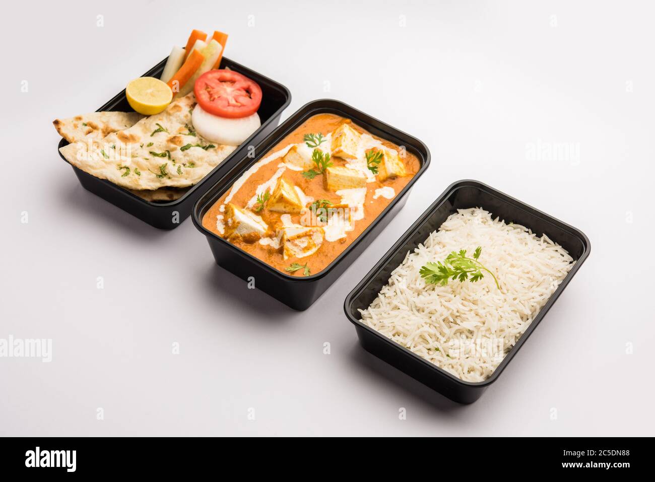 Paneer Butter Masala packed in plastic container or box, ready for home ...