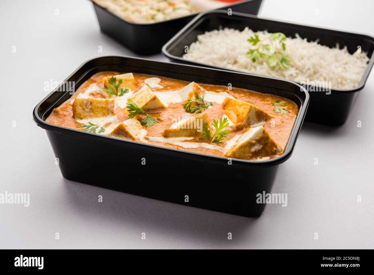 Paneer Butter Masala packed in plastic container or box, ready for home ...
