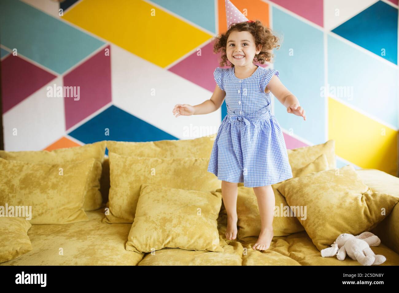Baby girl jumping sofa hi-res stock photography and images - Alamy