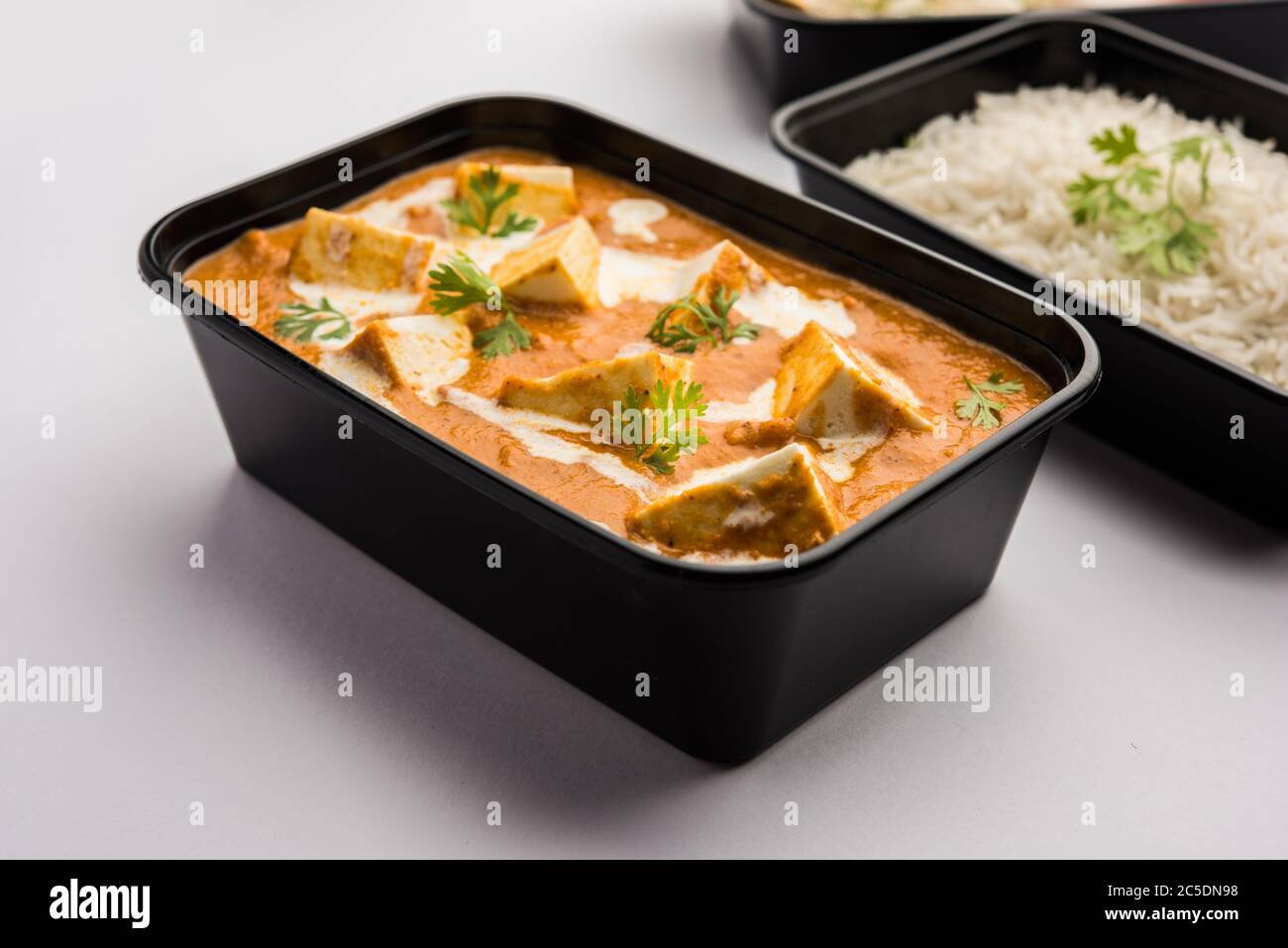 Paneer Butter Masala packed in plastic container or box, ready for home ...