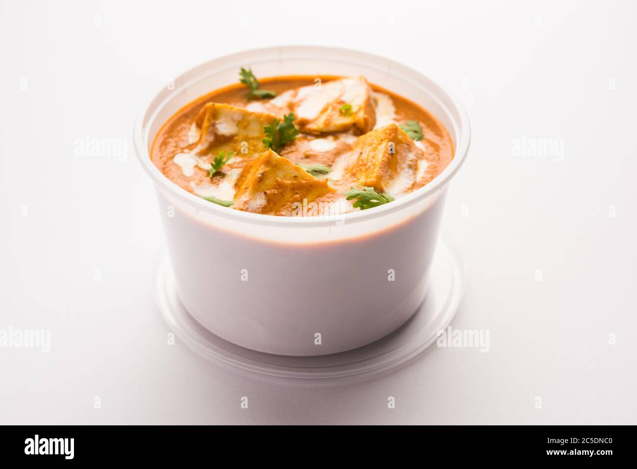 Paneer Butter Masala packed in plastic container or box, ready for home ...