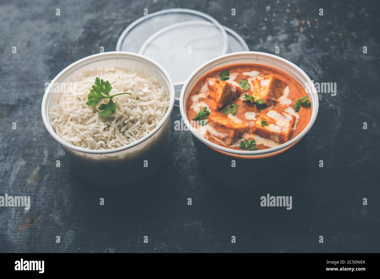 Paneer Butter Masala packed in plastic container or box, ready for home ...