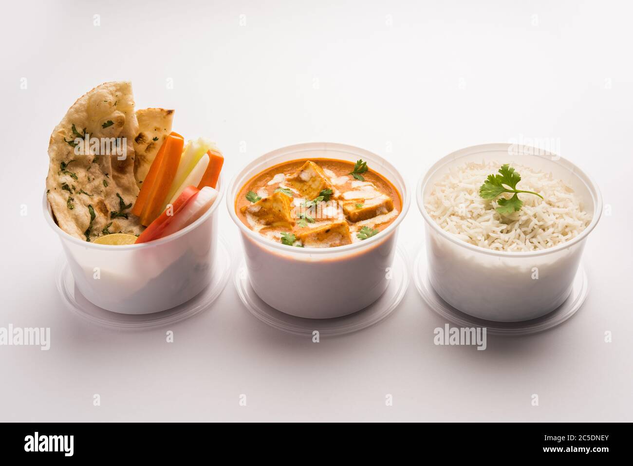 Paneer Butter Masala packed in plastic container or box, ready for home ...