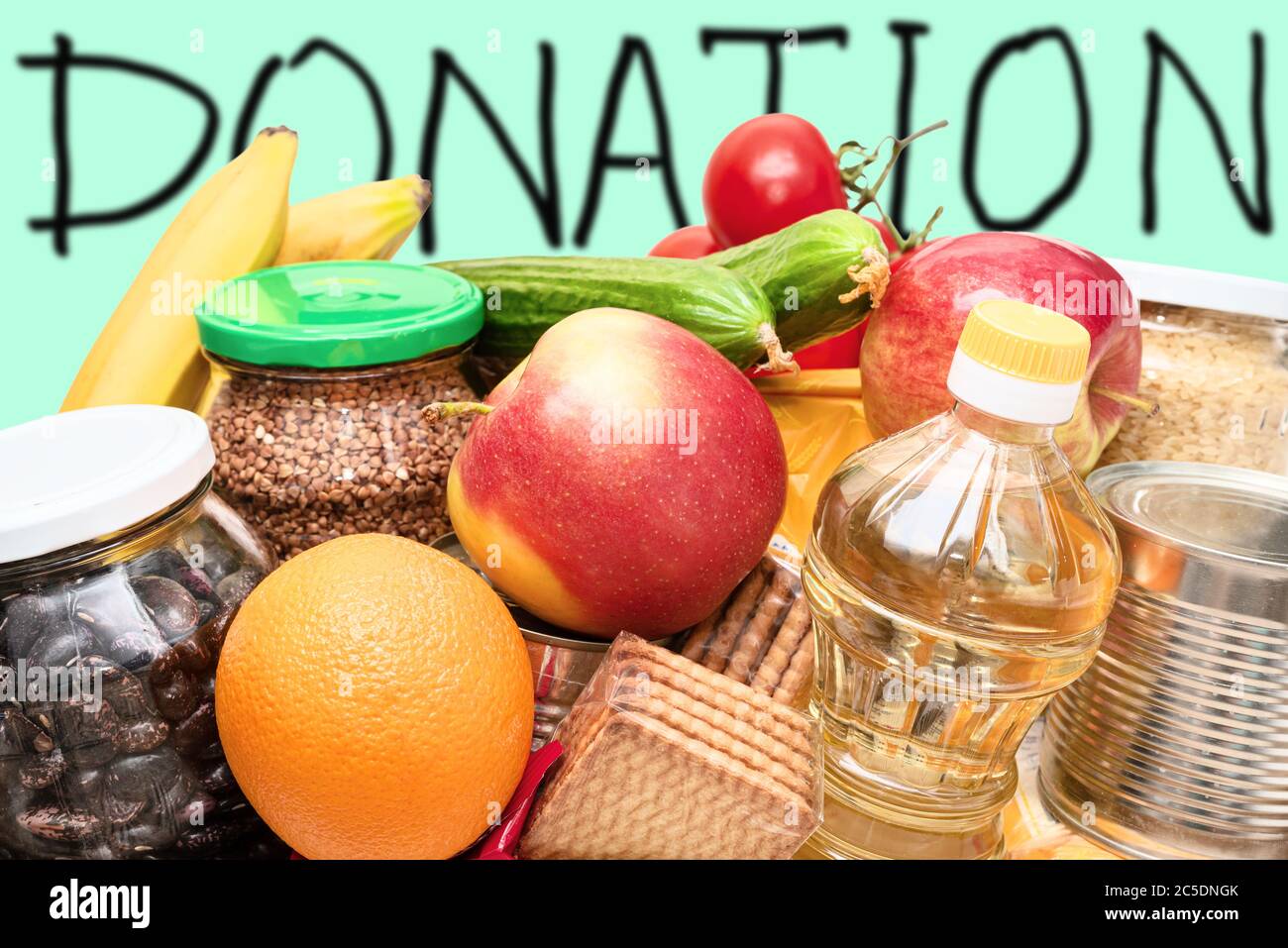 Closeup of different foodstuffs in donation box on neo mint background ...