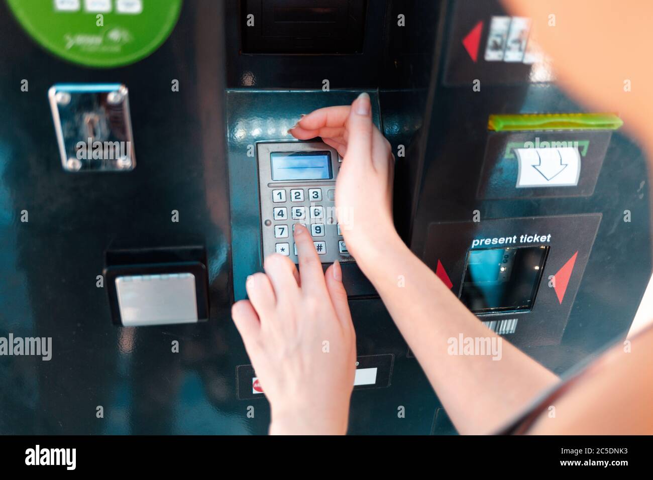 ATM and banking operations. The woman, covering his hand, enters the ...