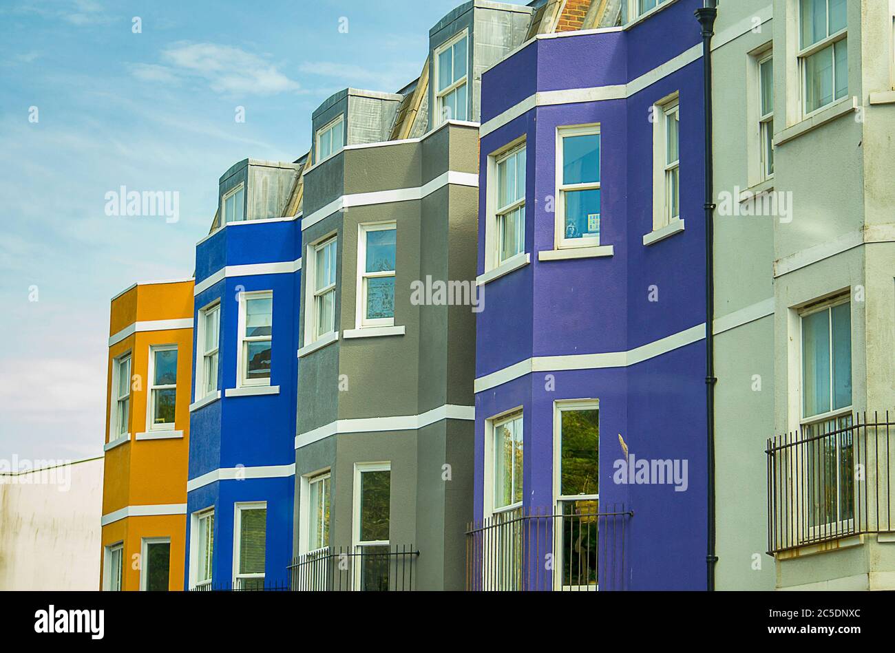 Houses of different colors in a row Stock Photo - Alamy