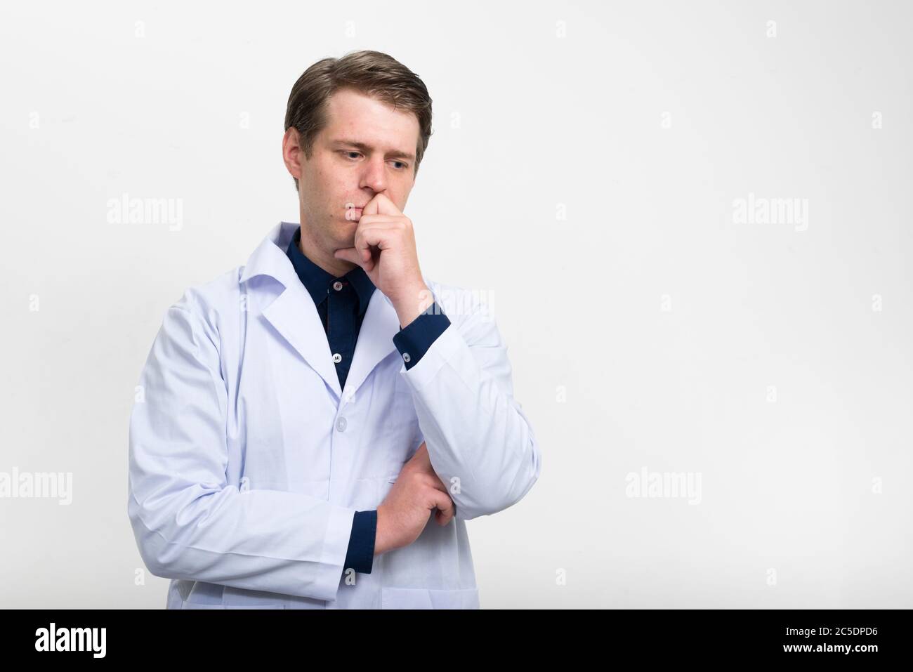 Portrait of stressed young man doctor thinking Stock Photo - Alamy