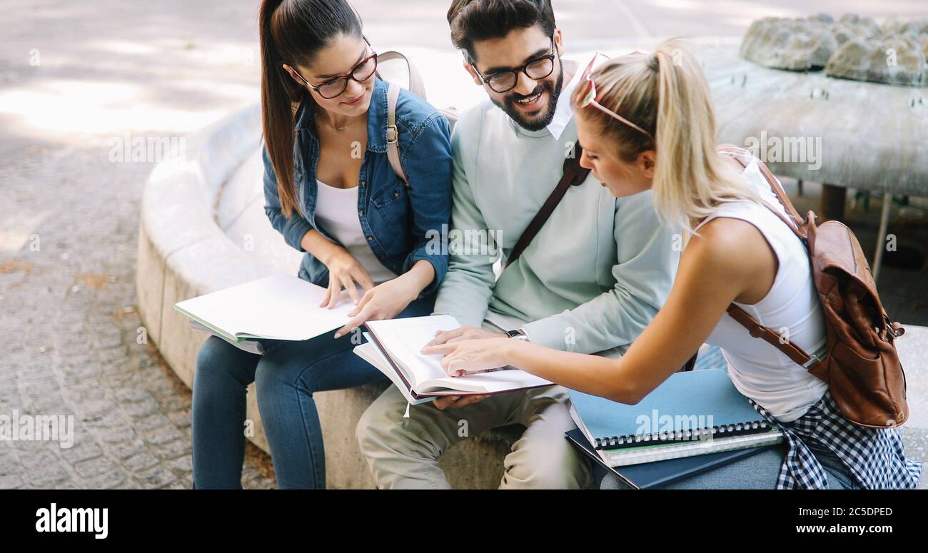 Happy group of students studying and learning together in college ...