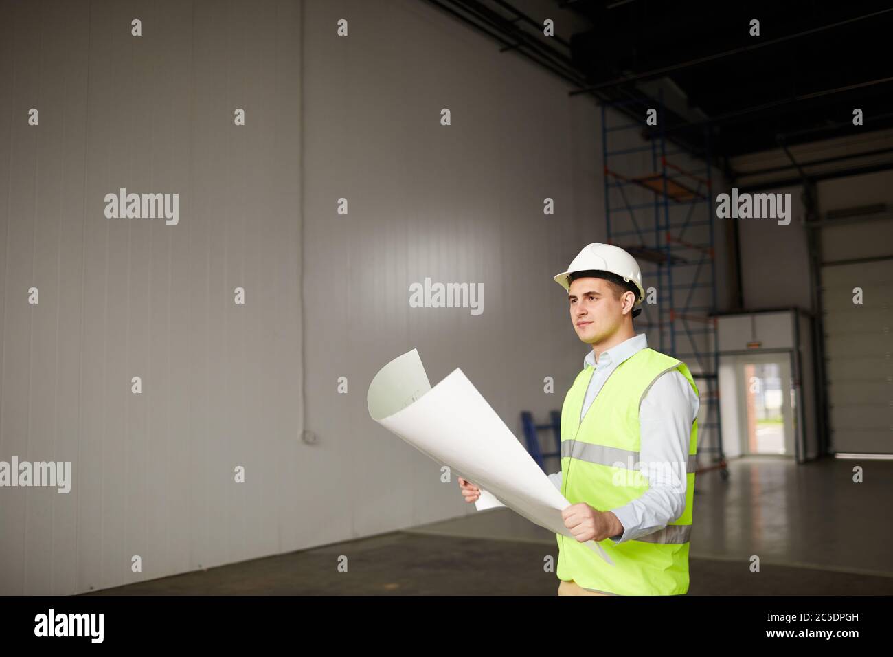 Construction engineer looking blueprint room hi-res stock photography ...