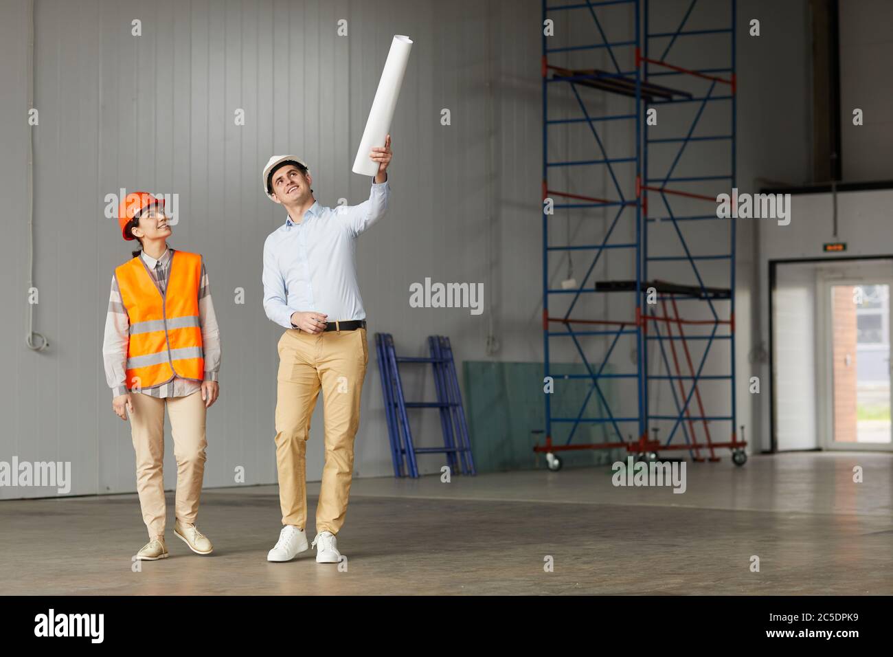Two Women Architect With Helmet And Plan High Resolution Stock ...