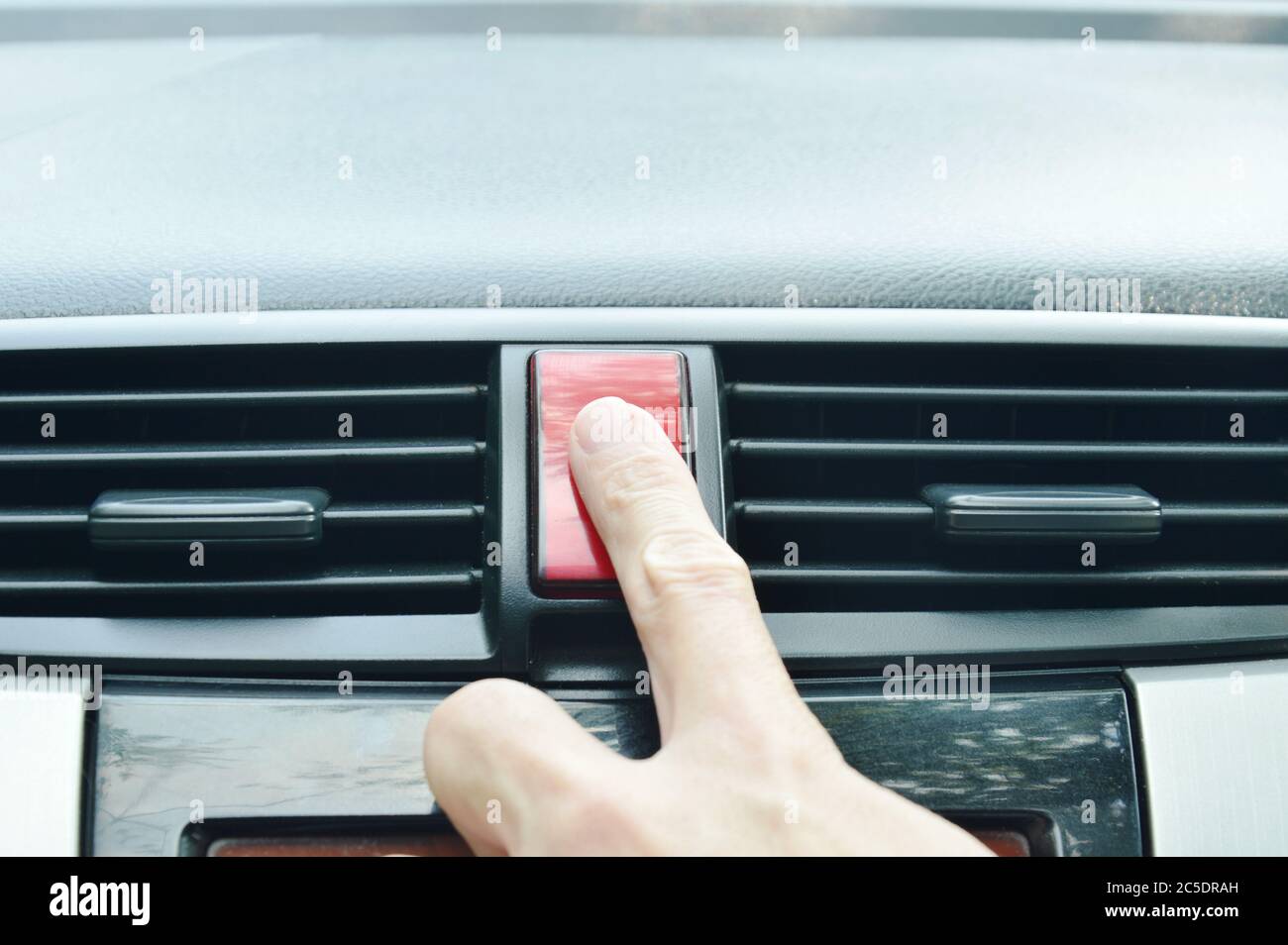 finger pushing on red button for opened emergency light in car Stock ...