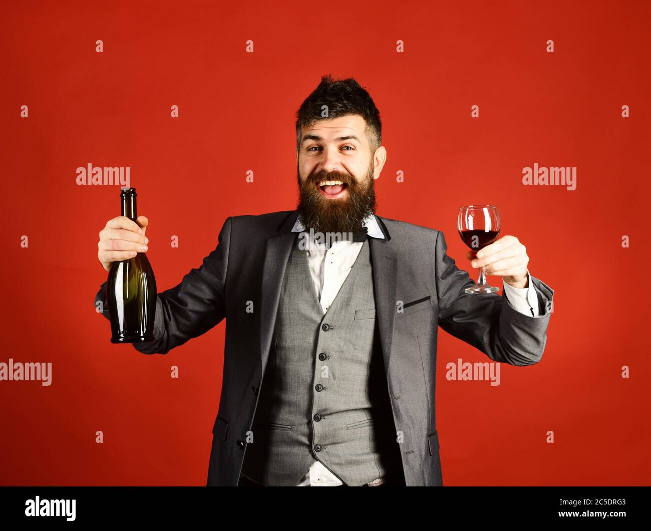 Degustator with beard and expensive wine on red background. Connoisseur ...