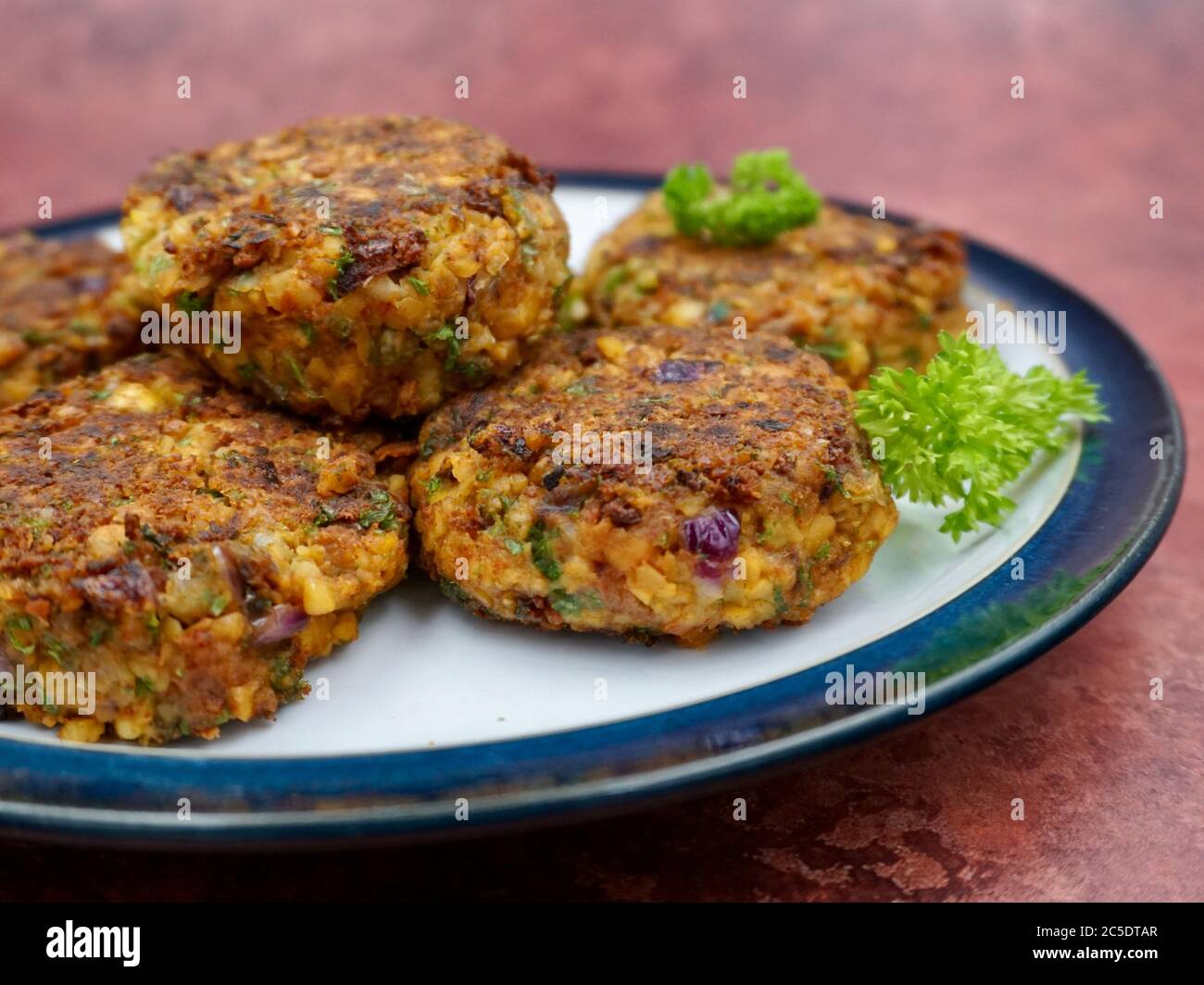 Homemade falafel, made from chick peas, on a plate with parsley garnish ...