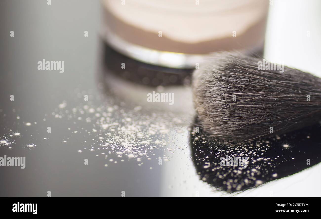 Closeup image of a face powder with a face brush Stock Photo - Alamy