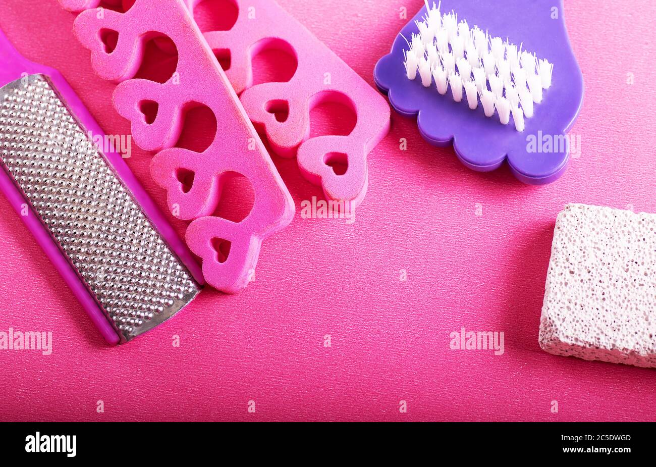Foot care products on a pink background Stock Photo - Alamy