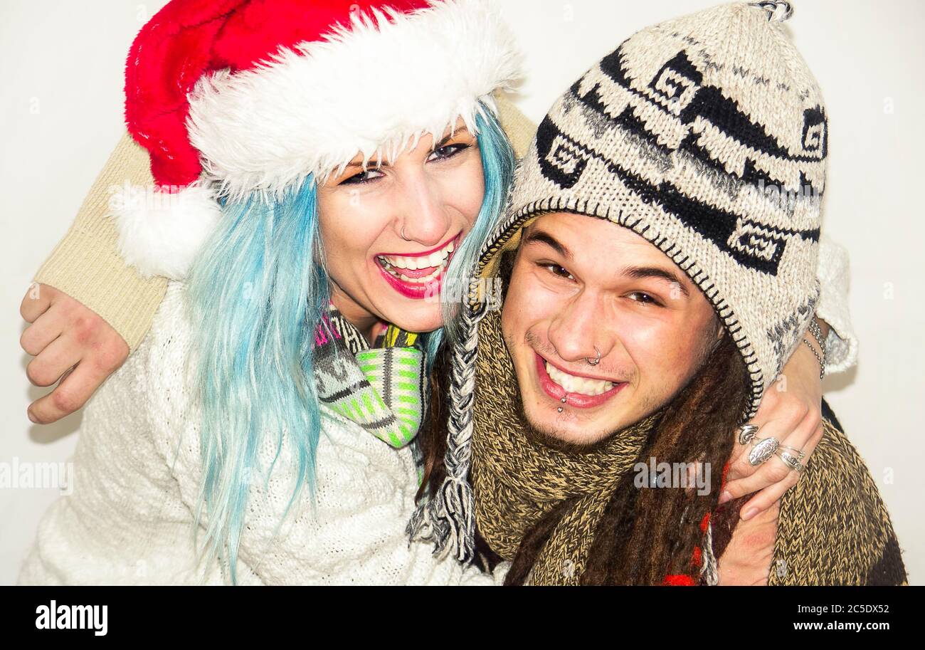 Cute young couple laughing in winter clothes on a white background ...