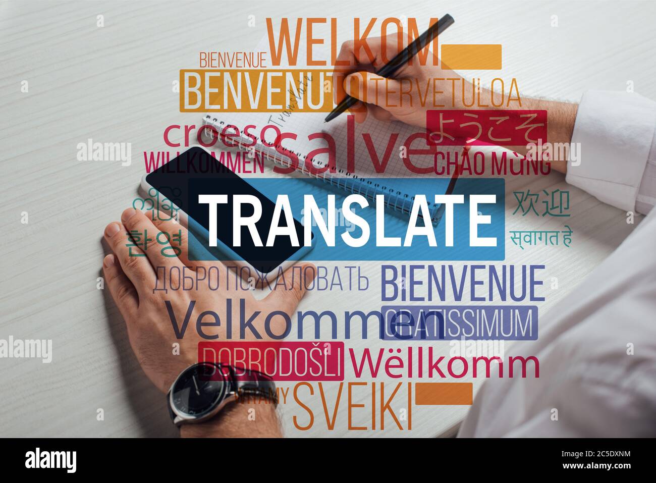 cropped view of translator writing in notepad with smartphone, welcome ...