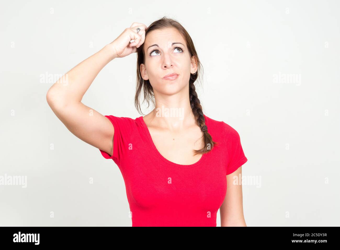 Portrait of confused young beautiful woman scratching head Stock Photo ...