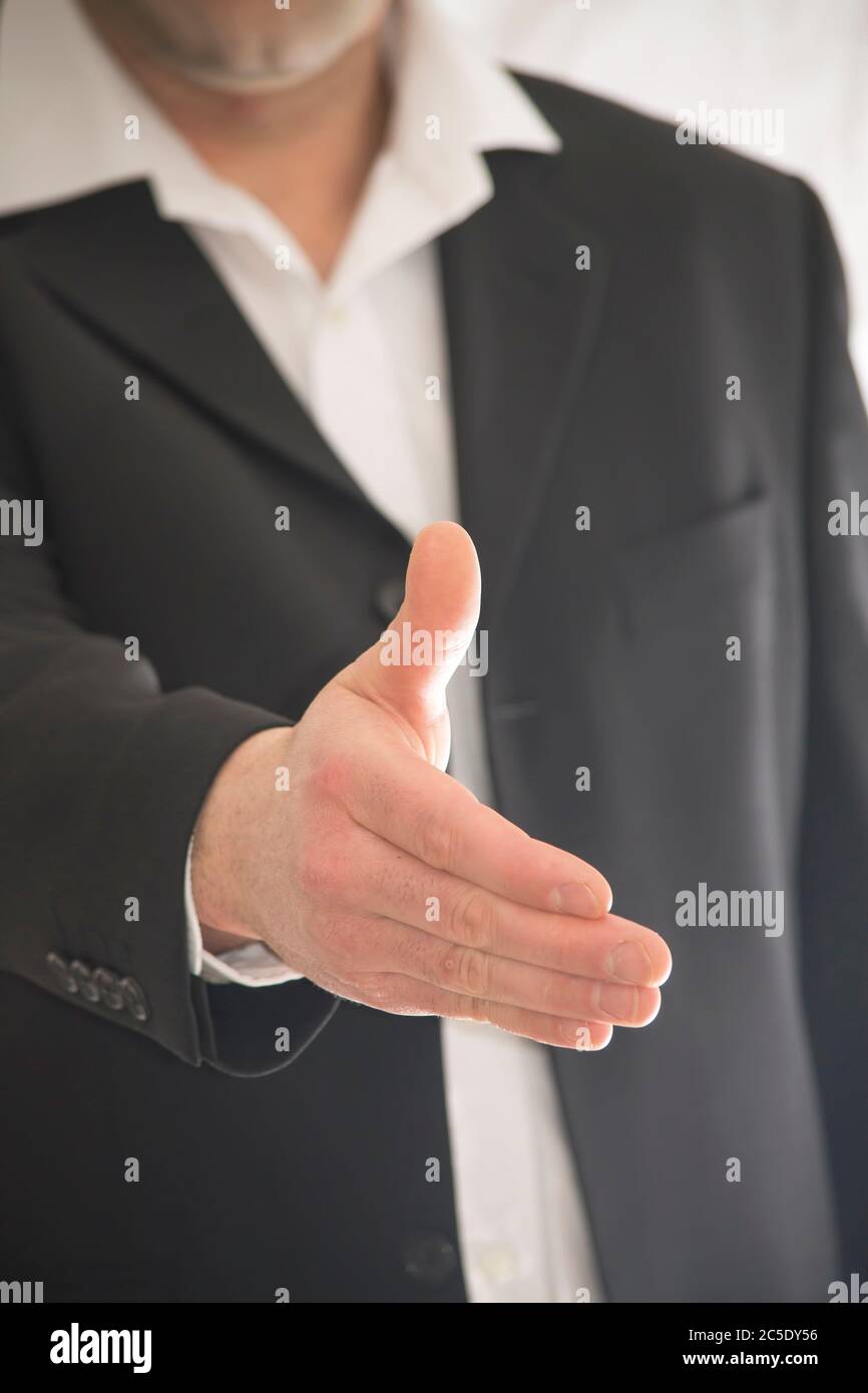 Man offering a handshake Stock Photo - Alamy