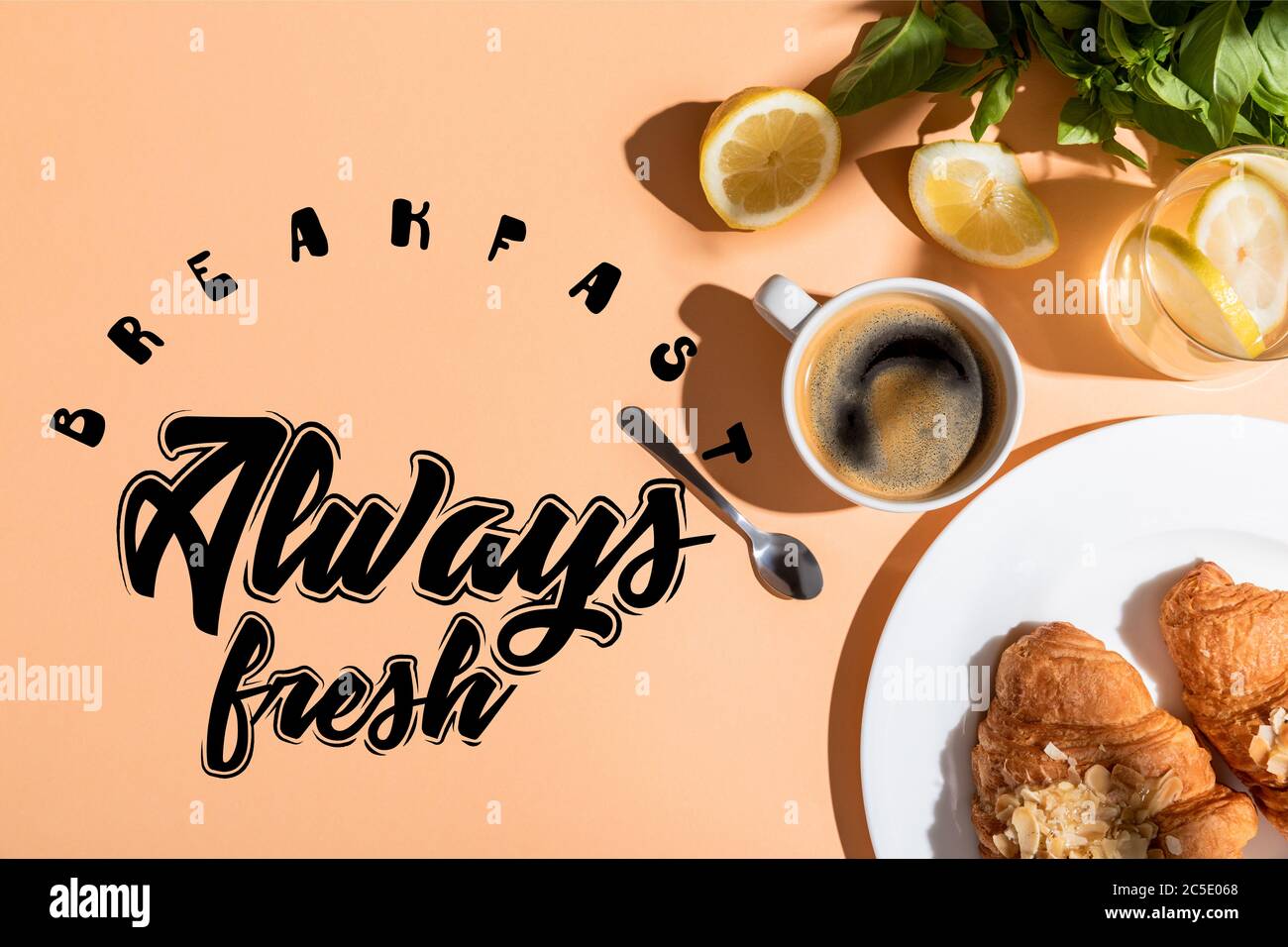 top view of coffee and croissants on beige table with breakfast always ...