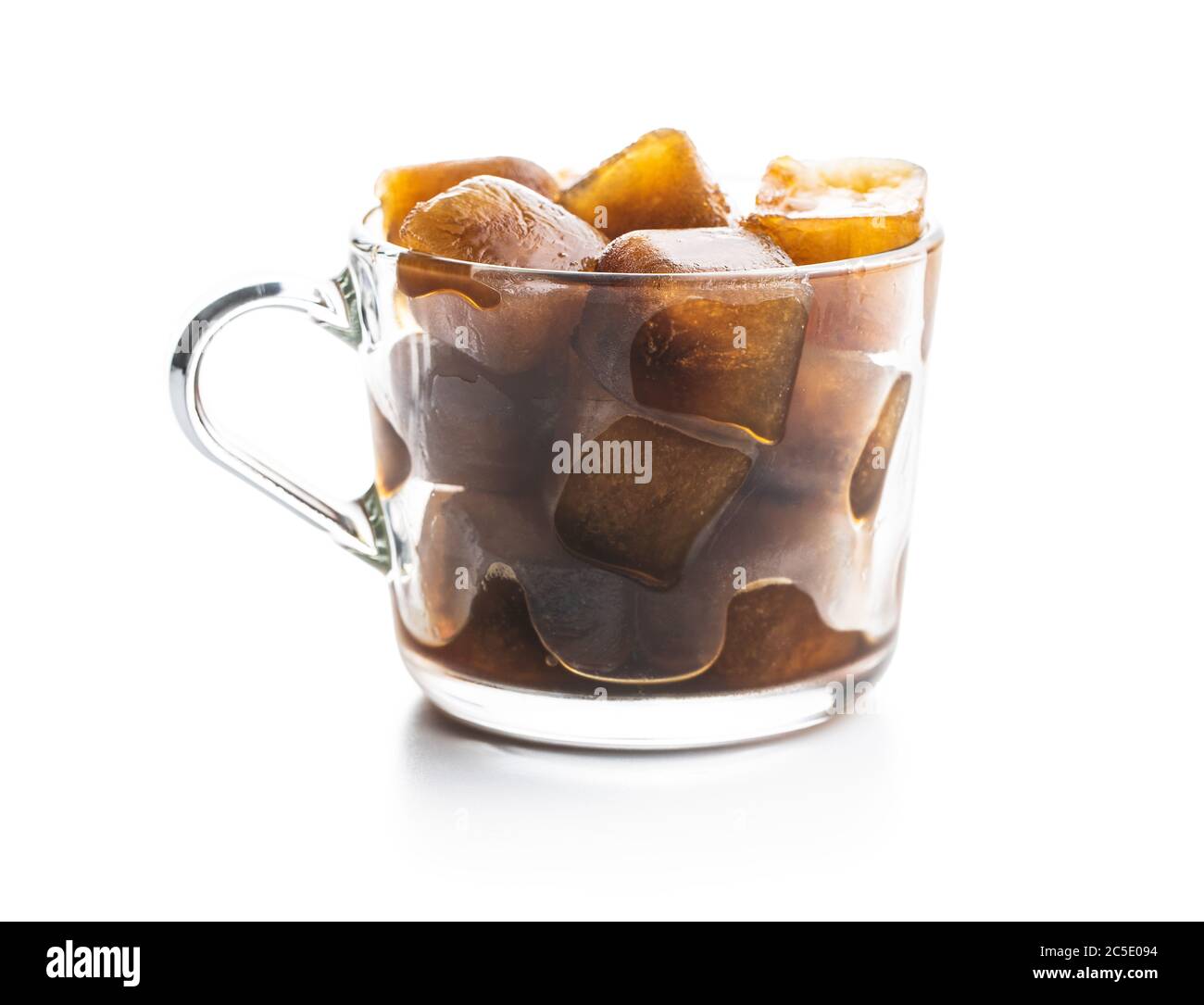 Frozen coffee. Coffee ice cubes in glass cup isolated on white ...