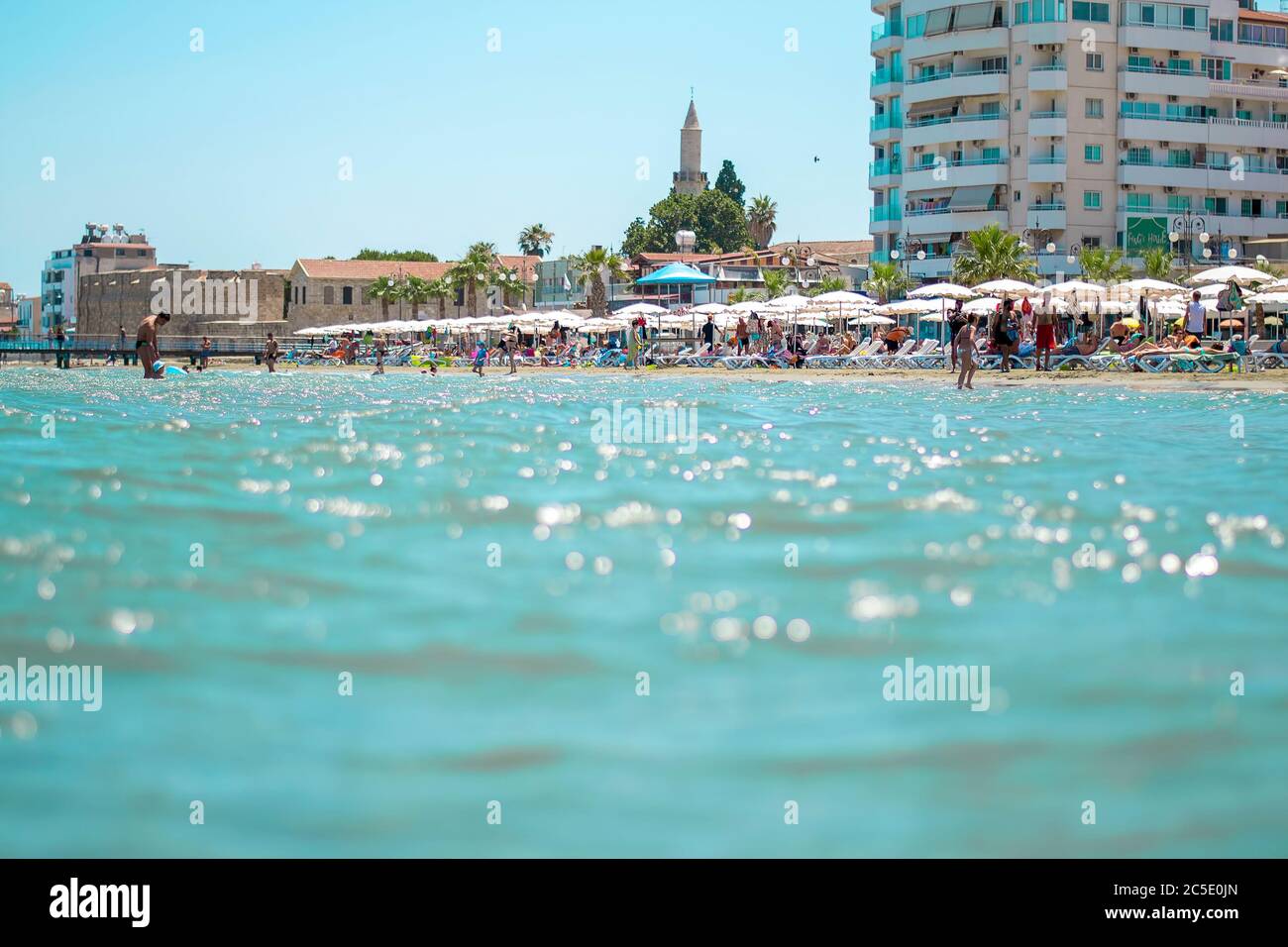 Larnaca, Cyprus - June 24, 2015. Larnaca beach in middle of June with ...