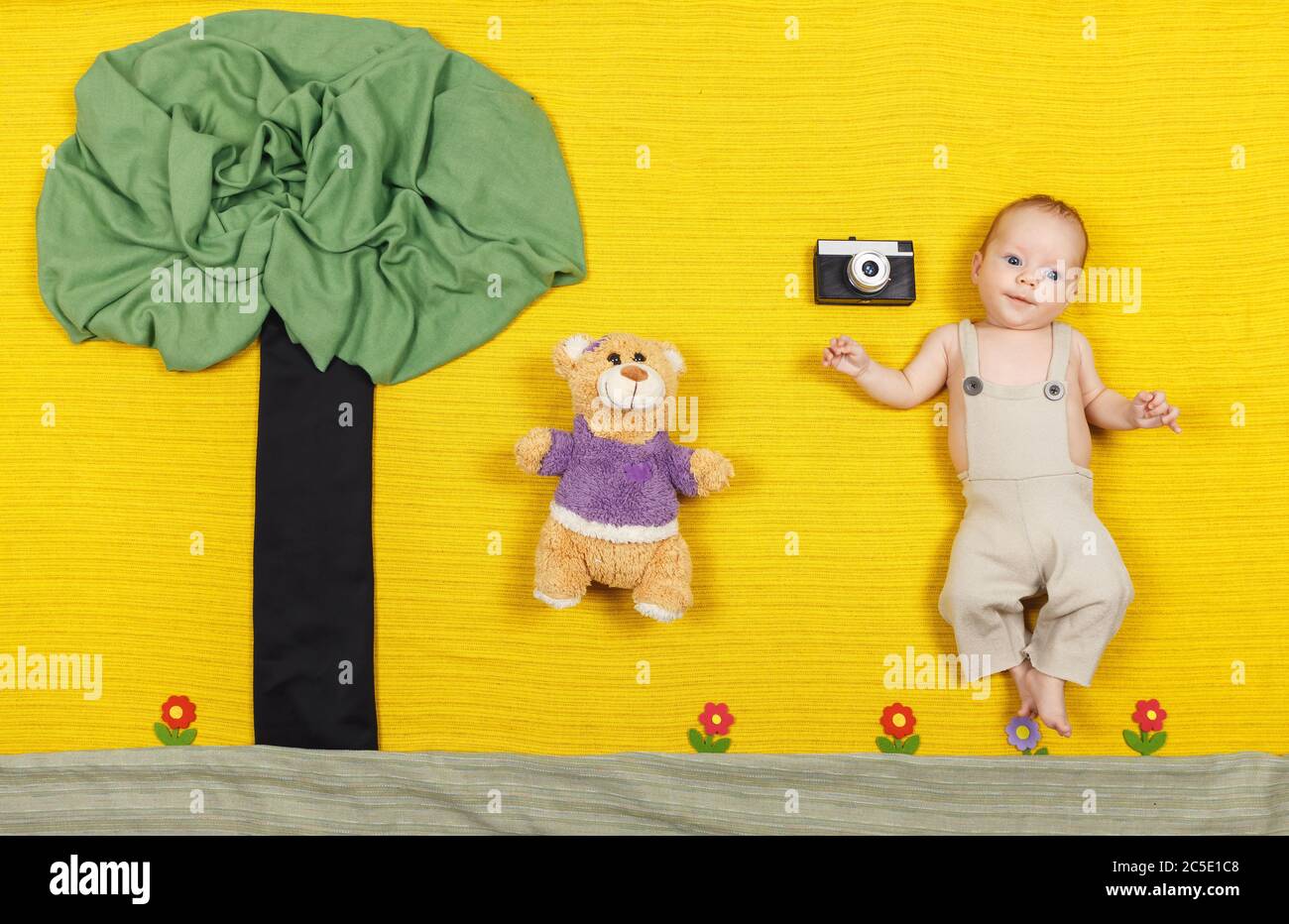 Funny laughing child is taking photos with vintage old retro camera ...