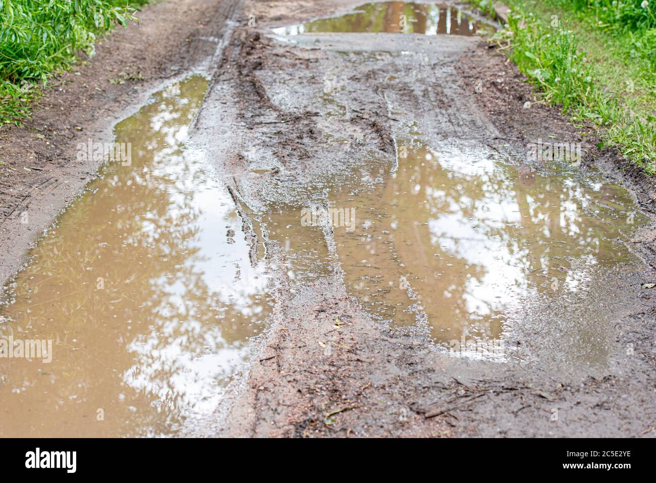 Puddle in country lane hi-res stock photography and images - Alamy