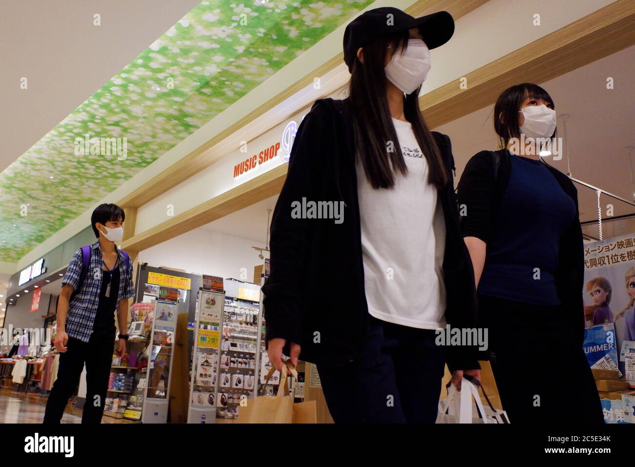 People wear face masks as they do their shopping at AEON Mall amid ...