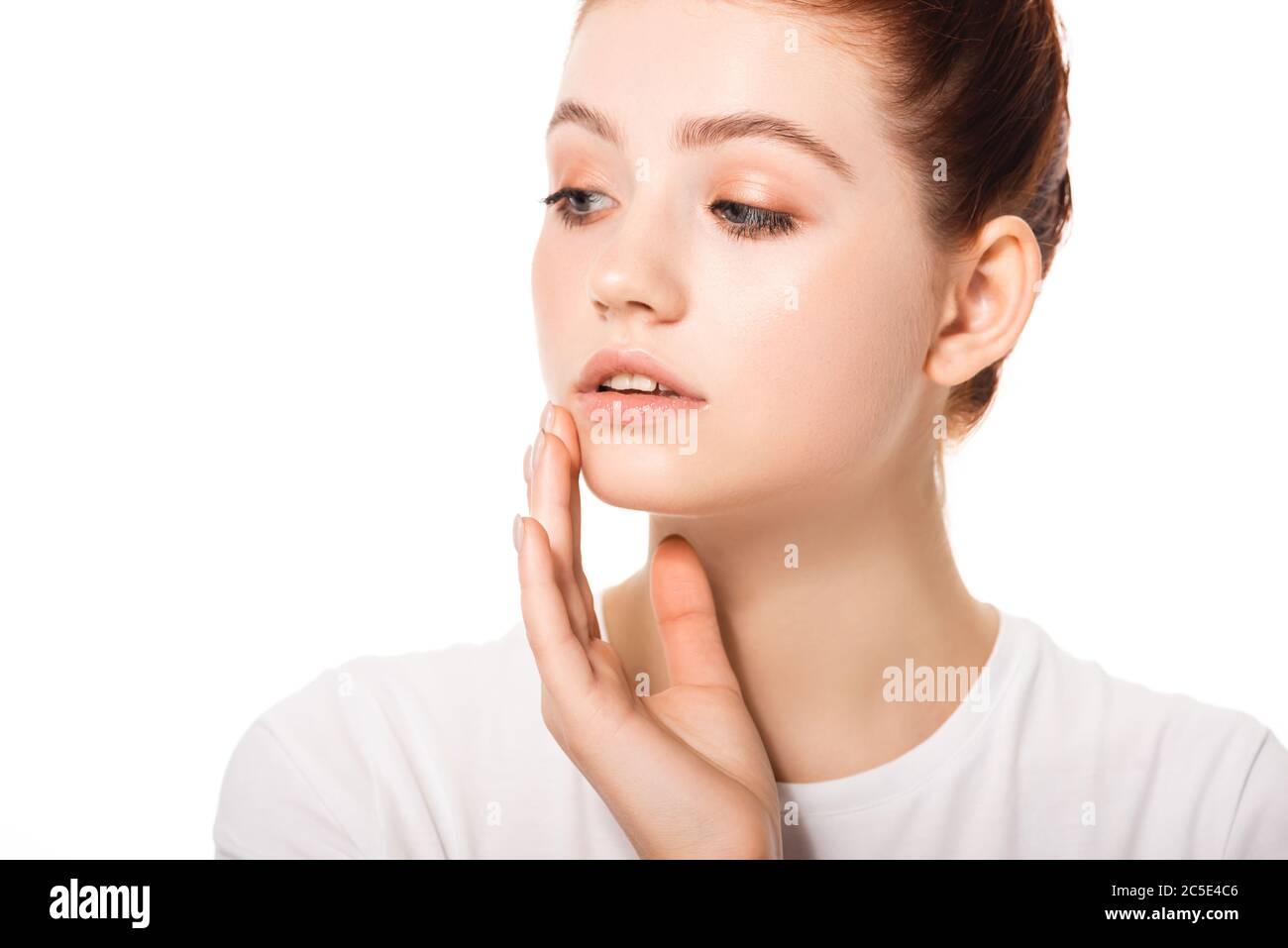 beautiful female teenager with clean skin touching face, isolated on ...