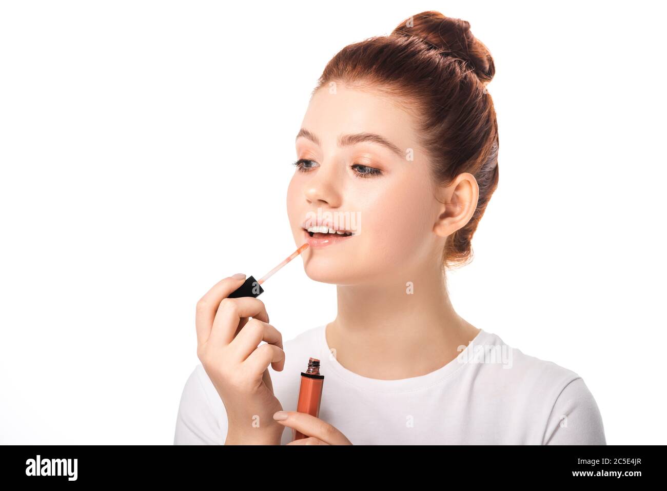beautiful teen girl applying lip gloss, isolated on white Stock Photo ...