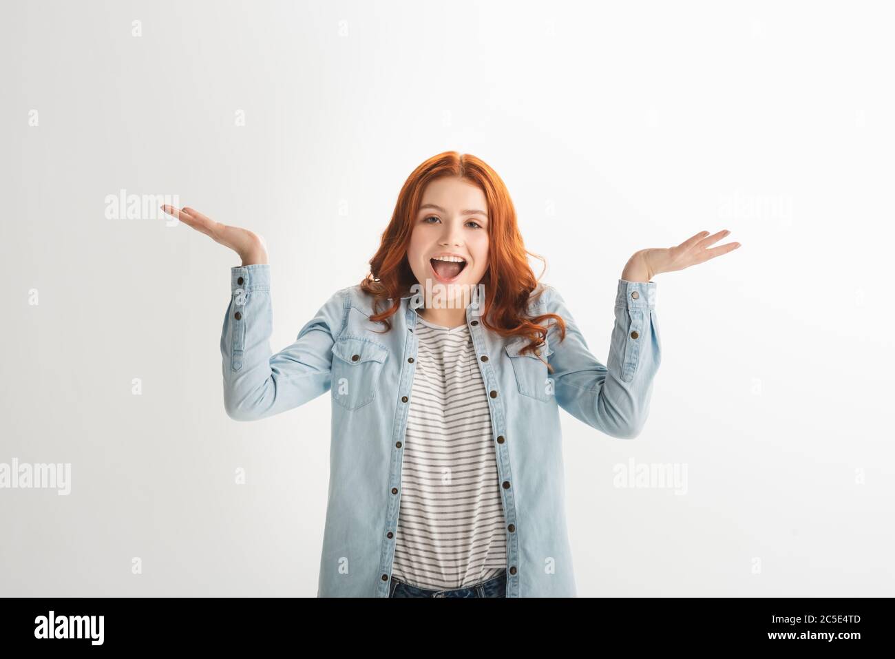 emotional redhead teen girl with shrug gesture, isolated on white Stock ...