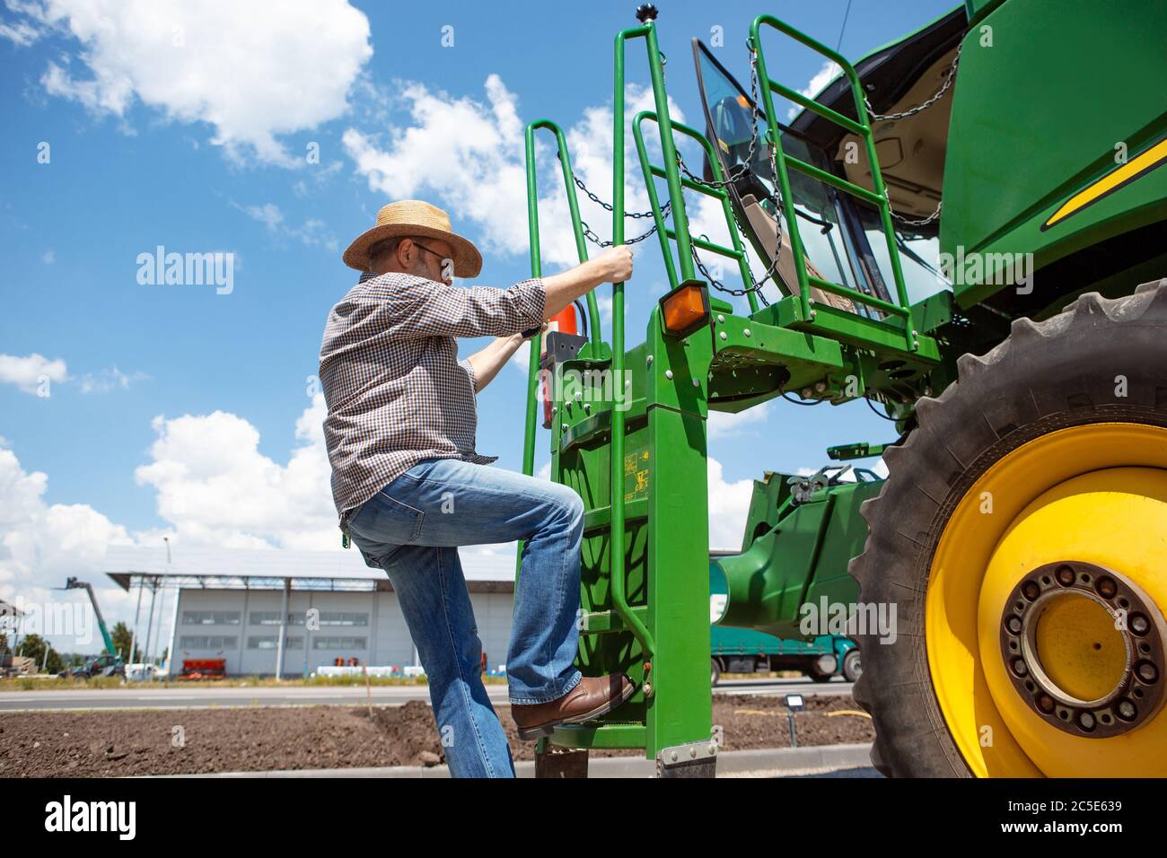 Professional farmer with a modern tractor at work process. Looks ...