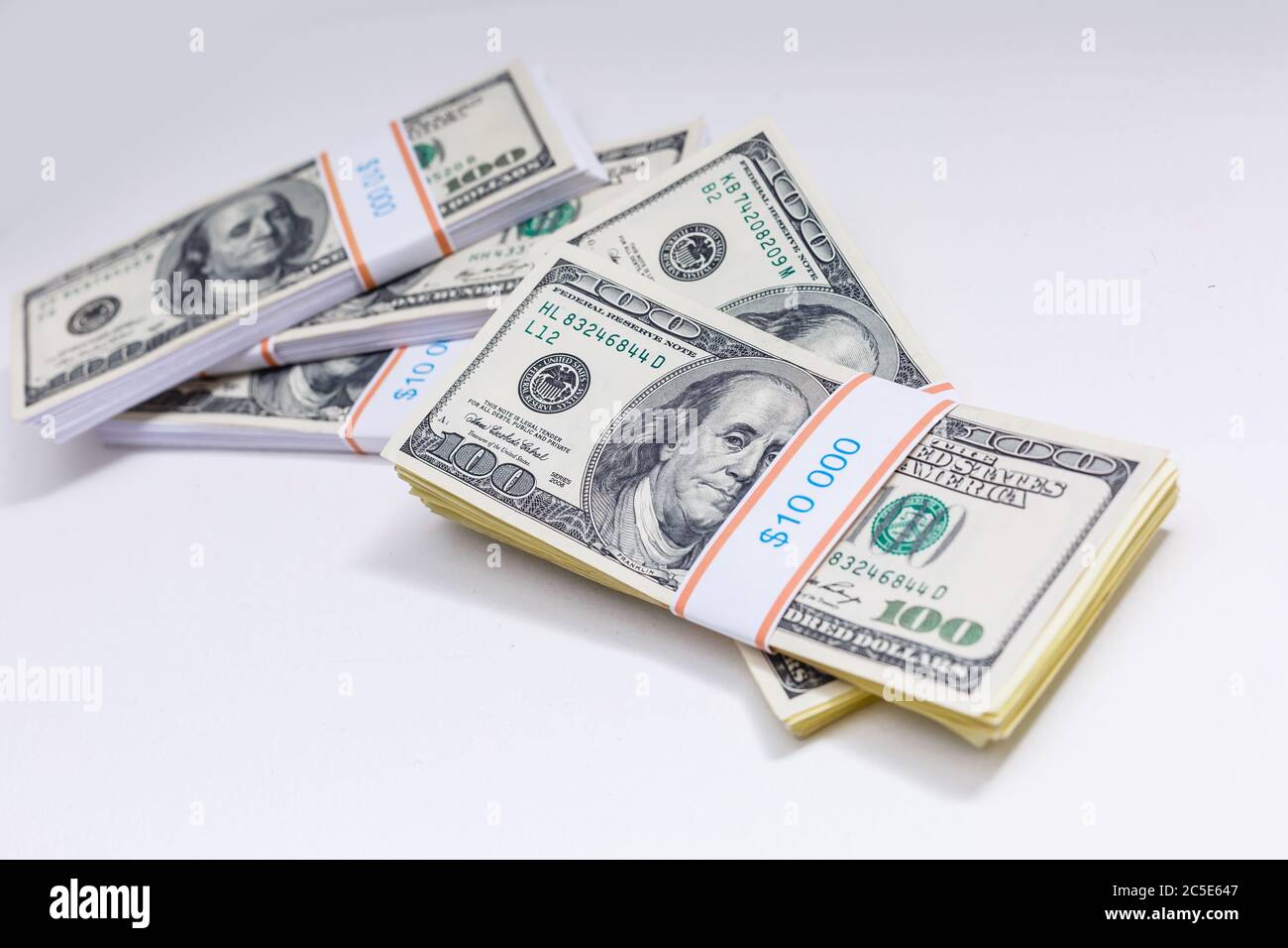 Set of a packs of dollars with a rubber band isolated on a white ...