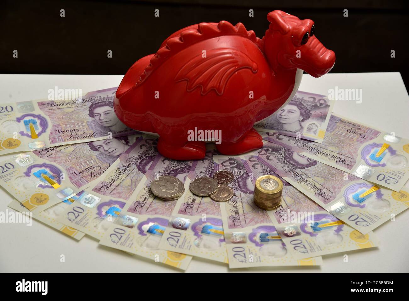 Picture shows a generic money picture and a red dragon money box ...