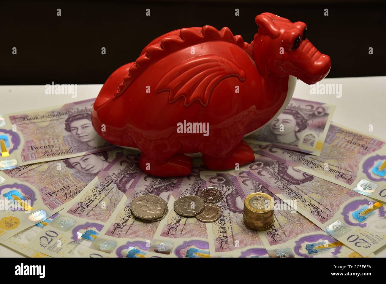 Picture shows a generic money picture and a red dragon money box ...
