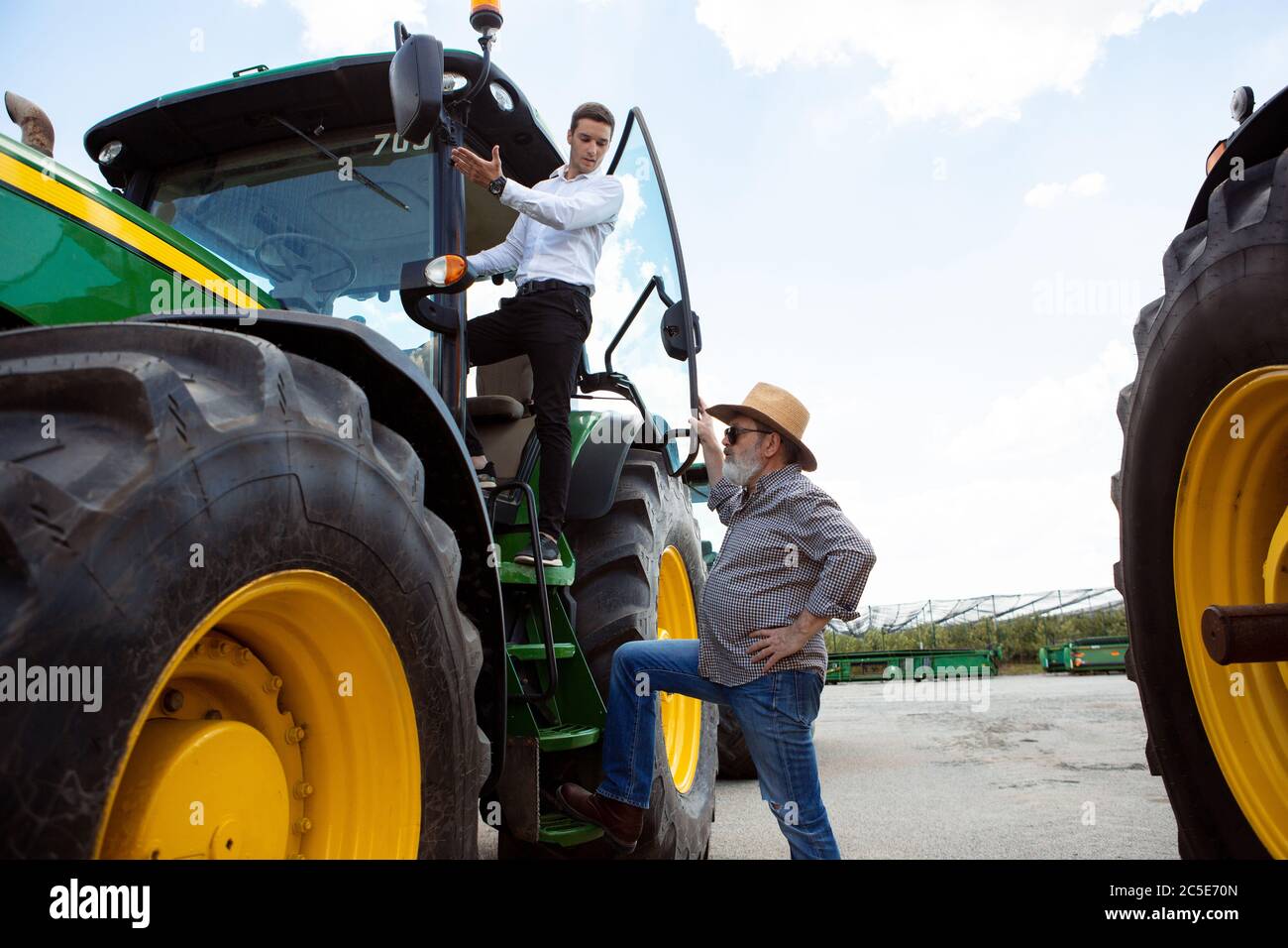 Professional farmer with a modern tractor at work process. Looks ...