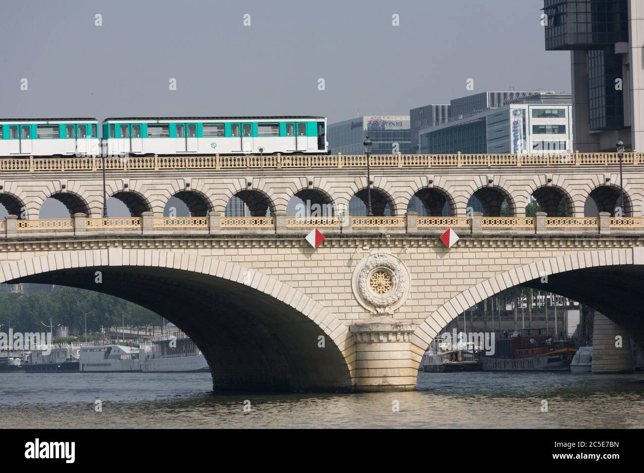 Metro train crosses bridge over Seine Stock Photo - Alamy