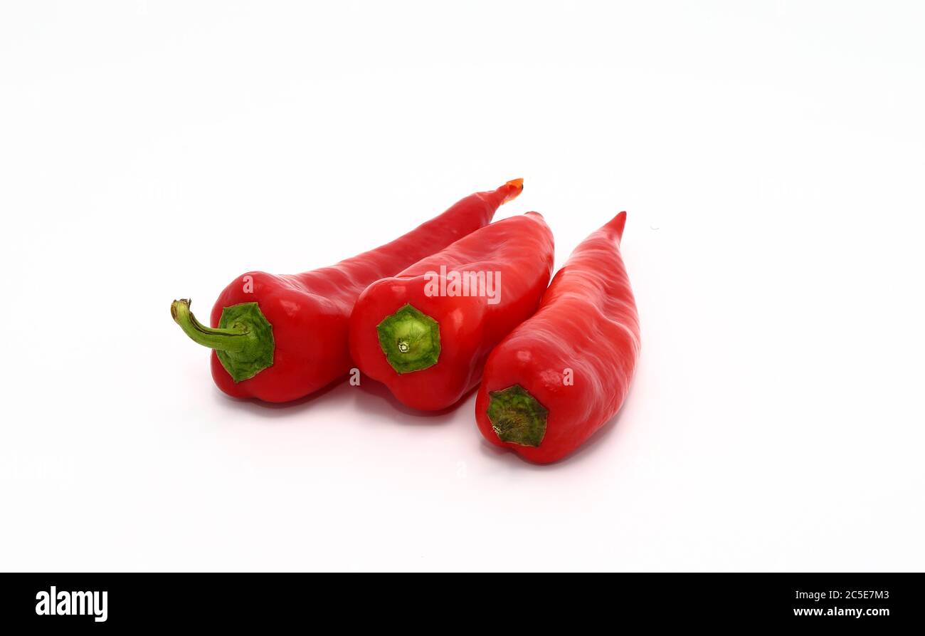 Three red ripe sweet peppers on a light background. Natural product ...