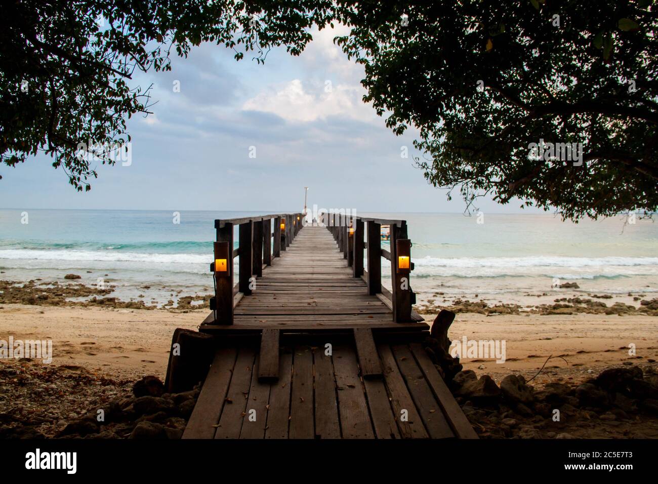 Wooden pier at isolated beach in Bali symmetrically centered Stock ...