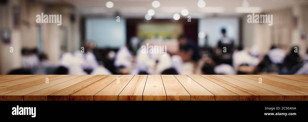 Panoramic empty clean wood counter table top on blur student study in ...