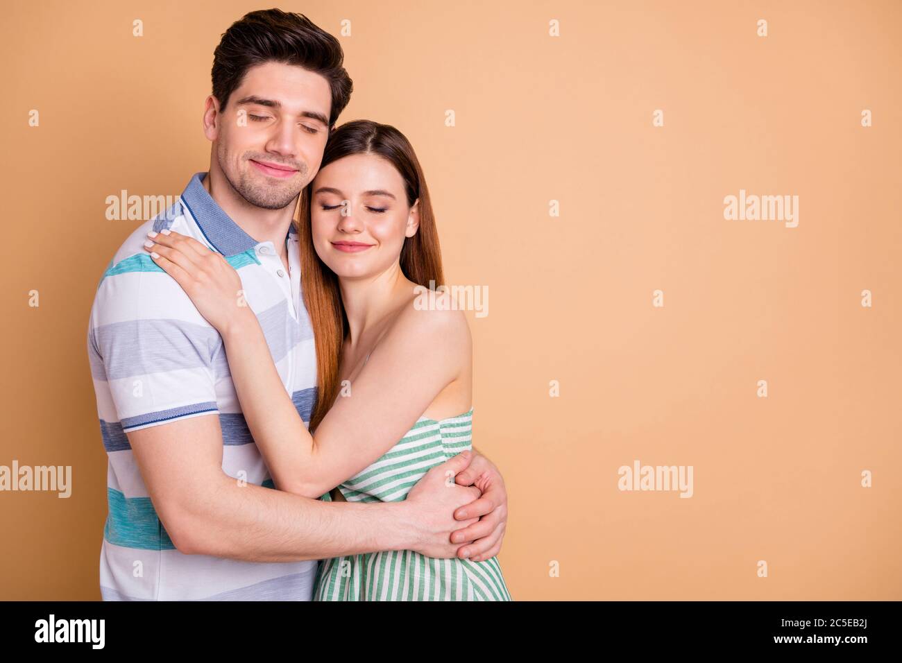 Portrait of passionate married couple man woman hug embrace cuddle ...