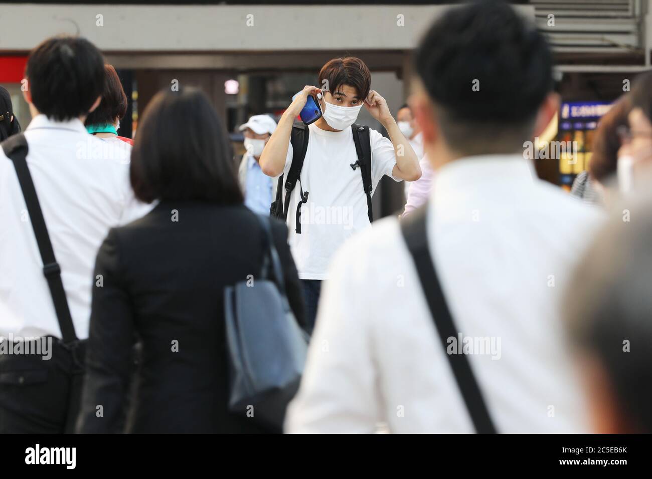 Tokyo, Japan. 2nd July, 2020. People wearing face masks walk on the ...