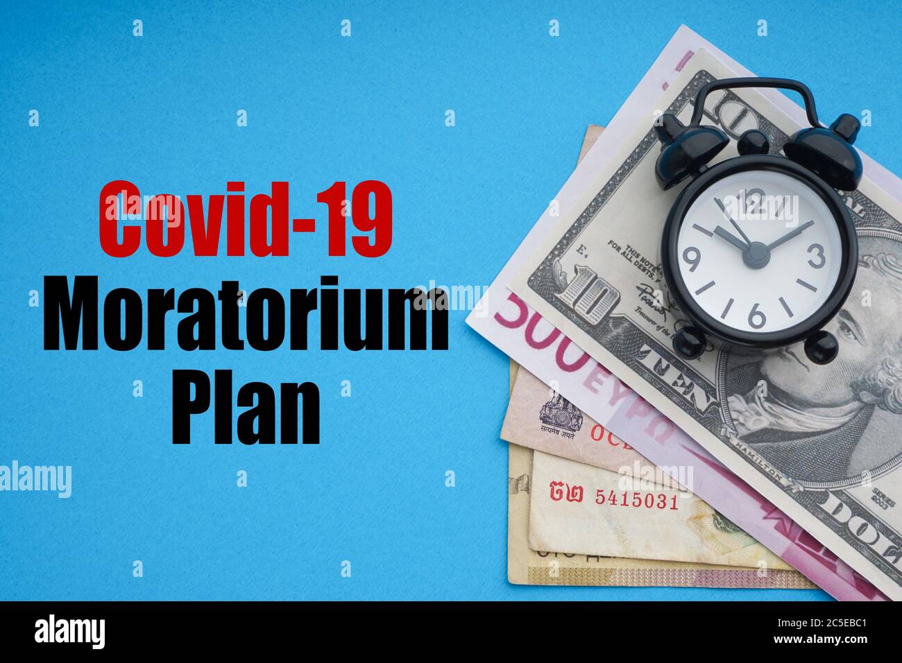 COVID19 MORATORIUM PLAN text with alarm clock and banknotes currencies ...