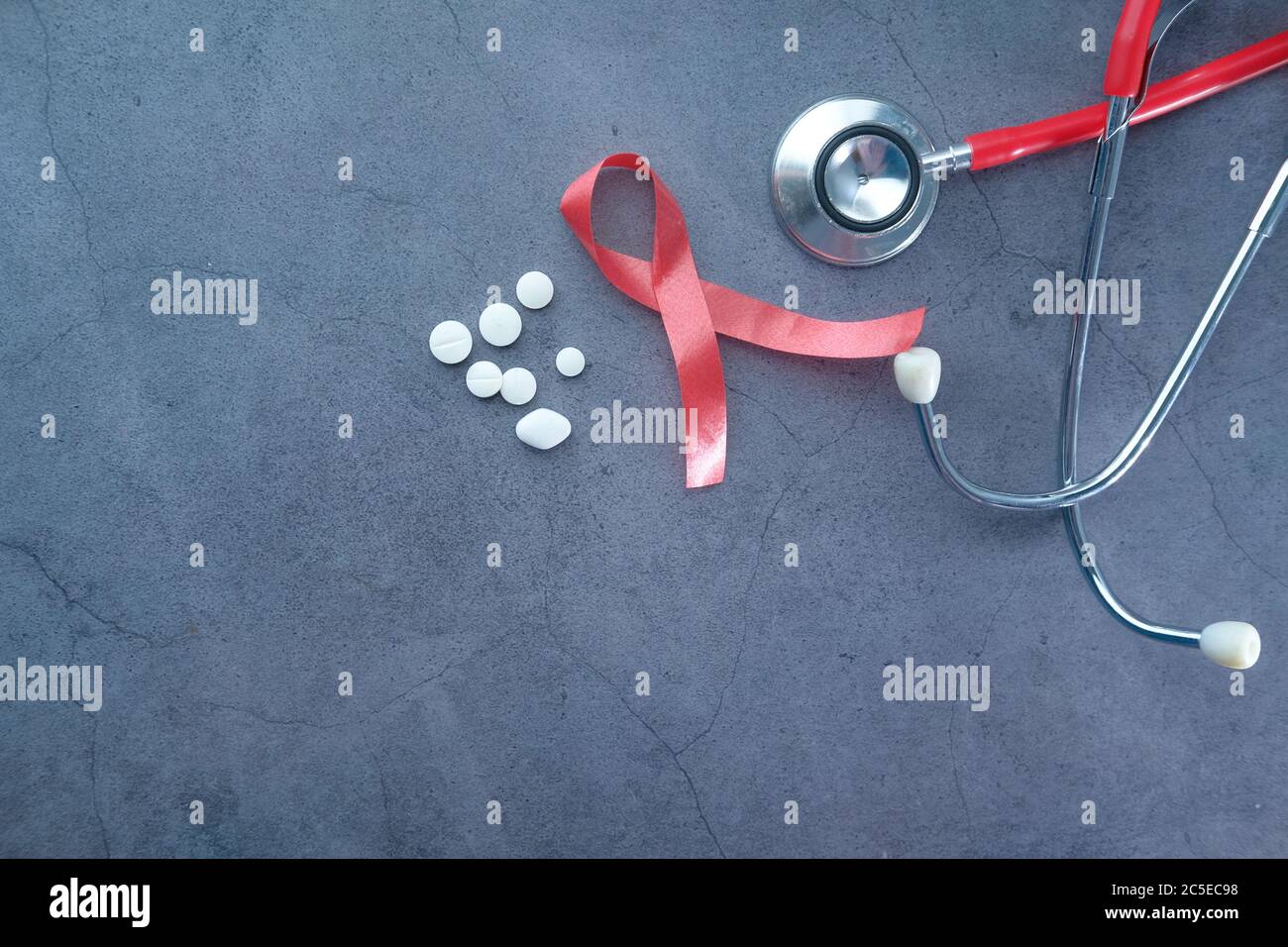 red HIV ribbon with stethoscope and pills on black background Stock ...